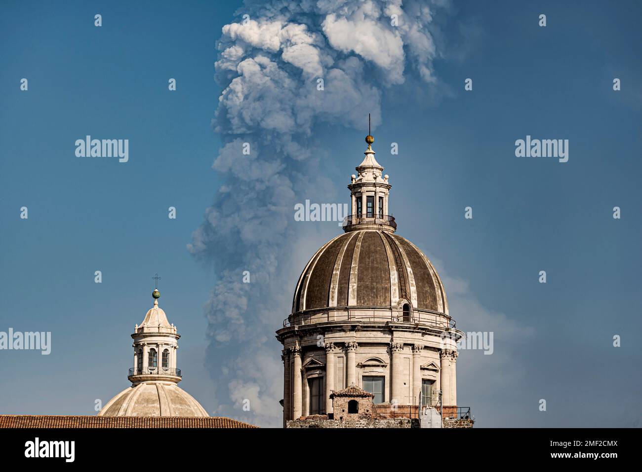 Smoke billows from a crater of Mount Etna volcano, background, as the ...