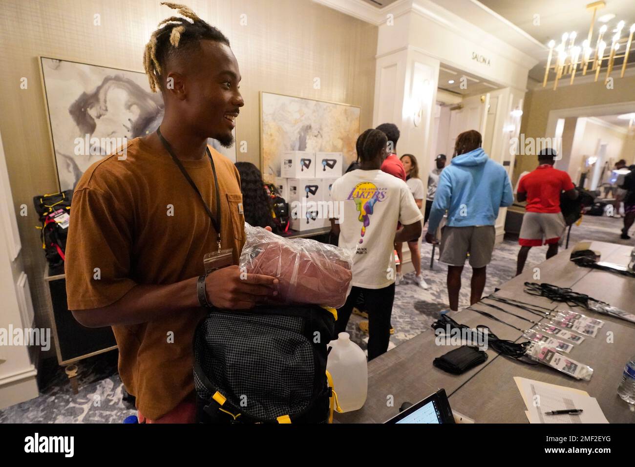 Former Texas A&M wide receiver Jhamon Ausbon picks up a backpack and ...