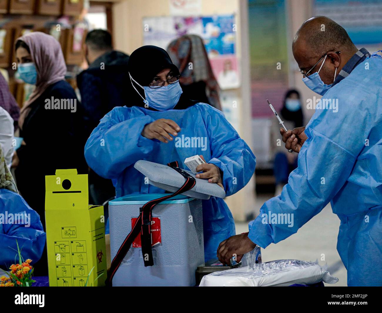 Iraqi health personnel wait to receive a Sinopharm coronavirus vaccine ...
