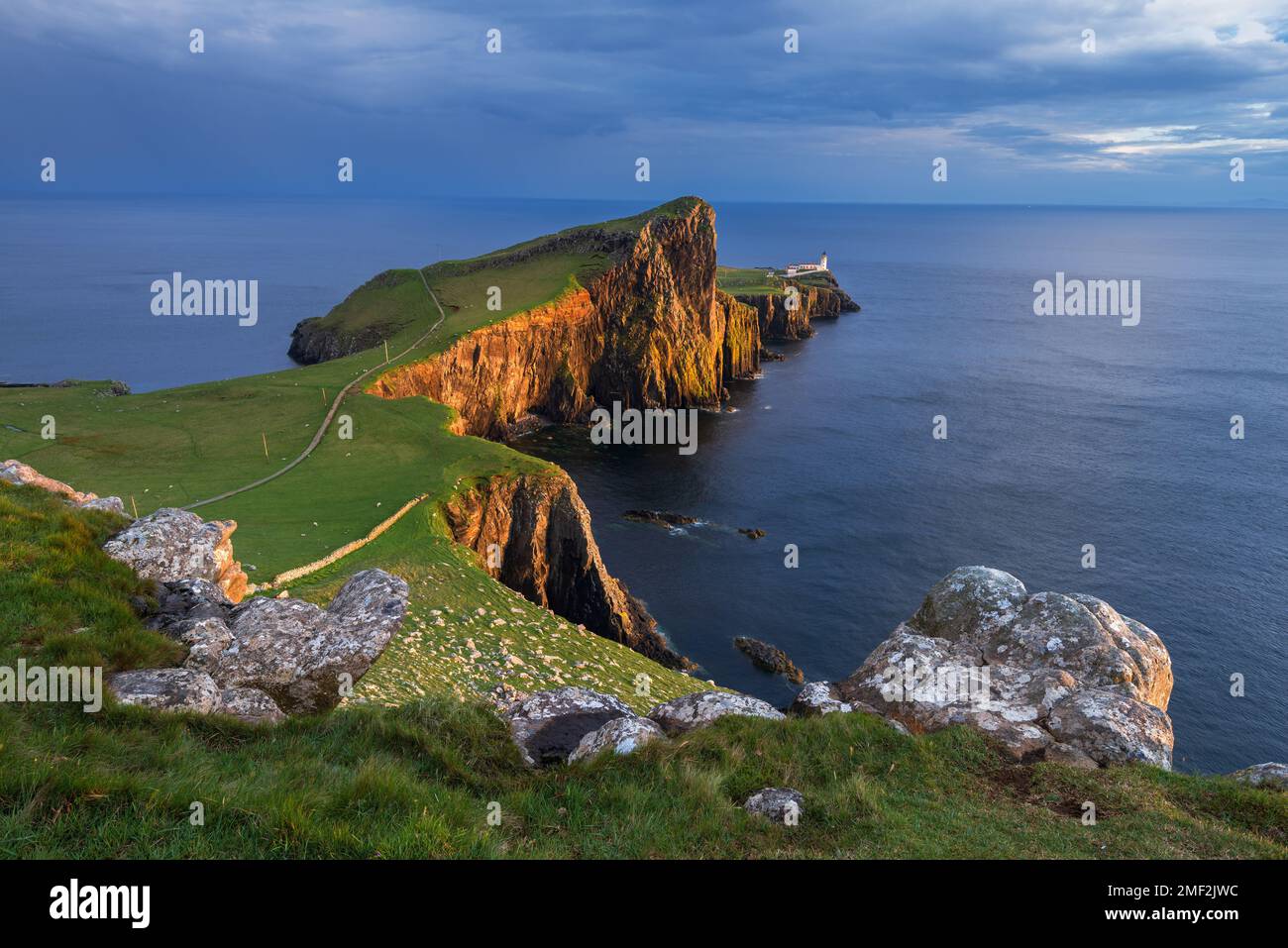 Neist Point Lighthouse bathed in golden light on a beautiful Summer ...