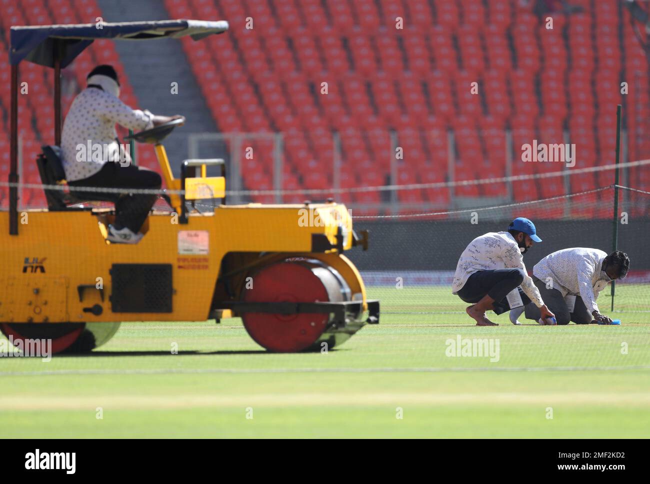 Ground staff work in the pitch area ahead of the fourth test cricket ...