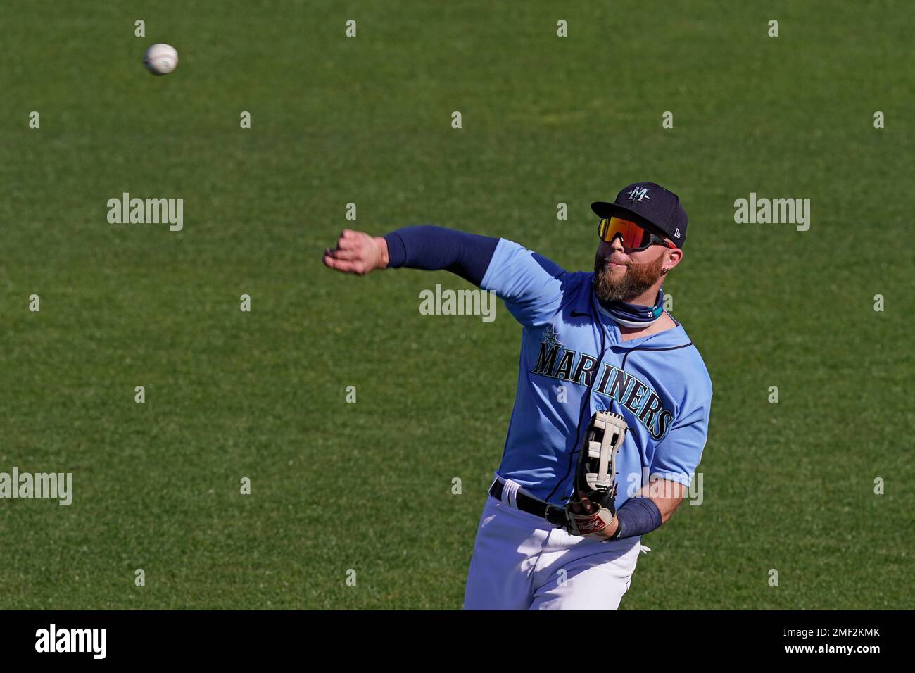 Seattle Mariners' Eric Filia throws during a spring training baseball ...