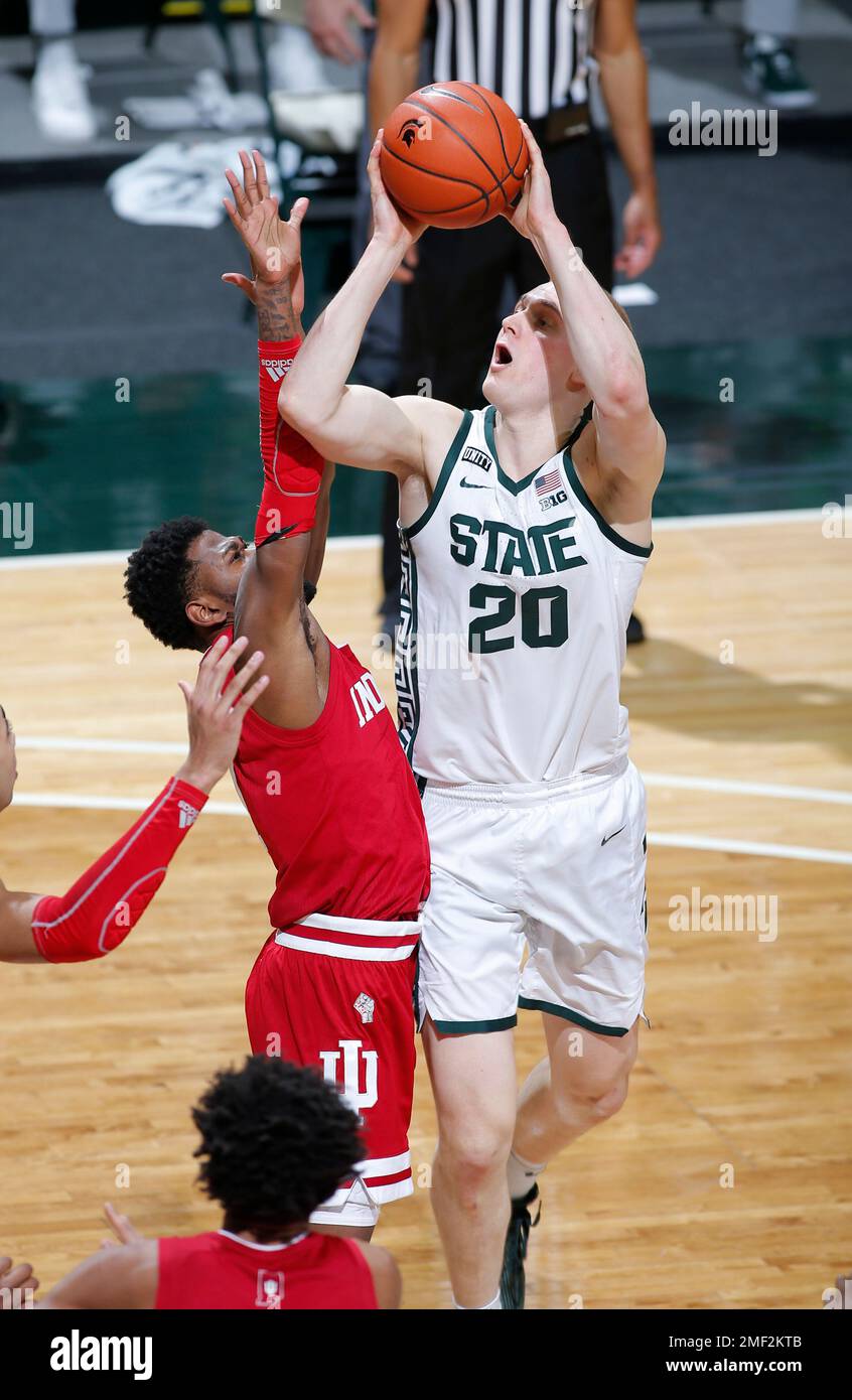 Michigan State's Joey Hauser, right, shoots against Indiana's Aljami ...