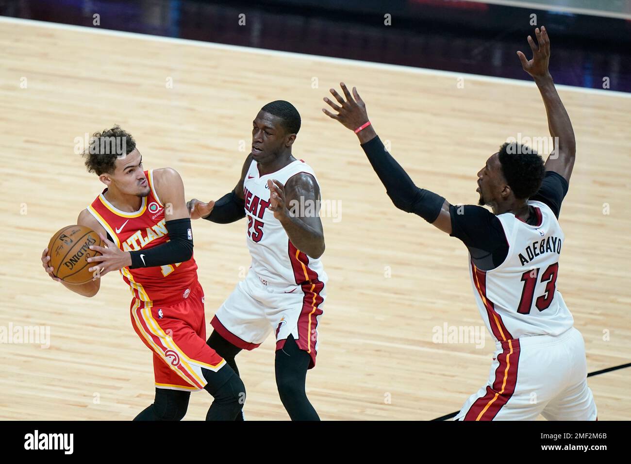 Atlanta Hawks guard Trae Young, left, looks for an opening past Miami ...