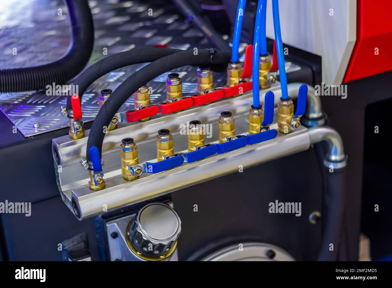 Part of automatic injection molding machine and plastic hoses at ...