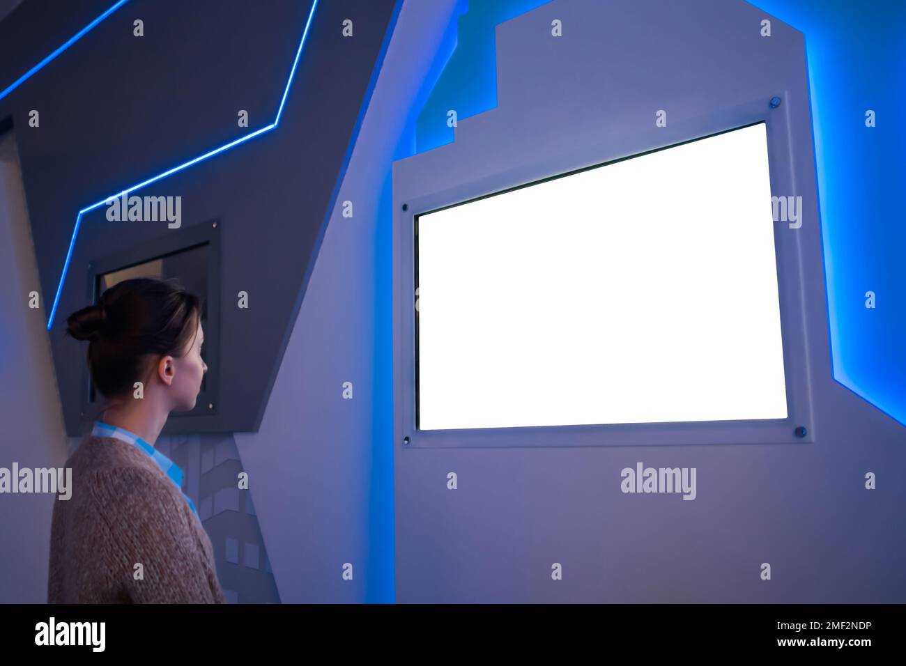 Woman looking at blank white display wall at exhibition - white screen ...