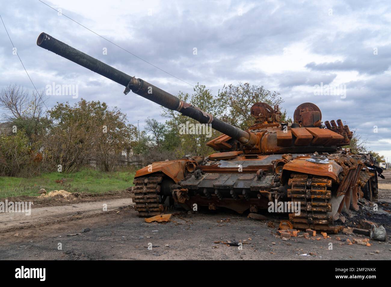 Countryside after the battle. A destroyed burnt battle tank stands on ...
