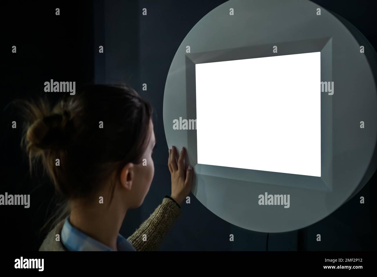 Woman looking at blank white display wall at exhibition - white screen ...