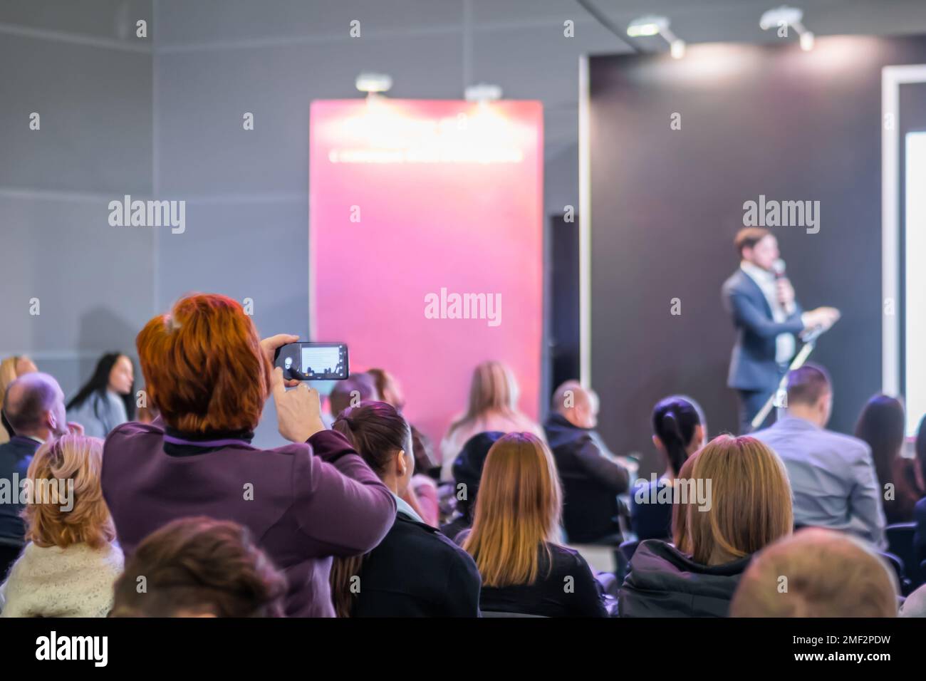 Back view of audience listening presentation at conference hall Stock ...