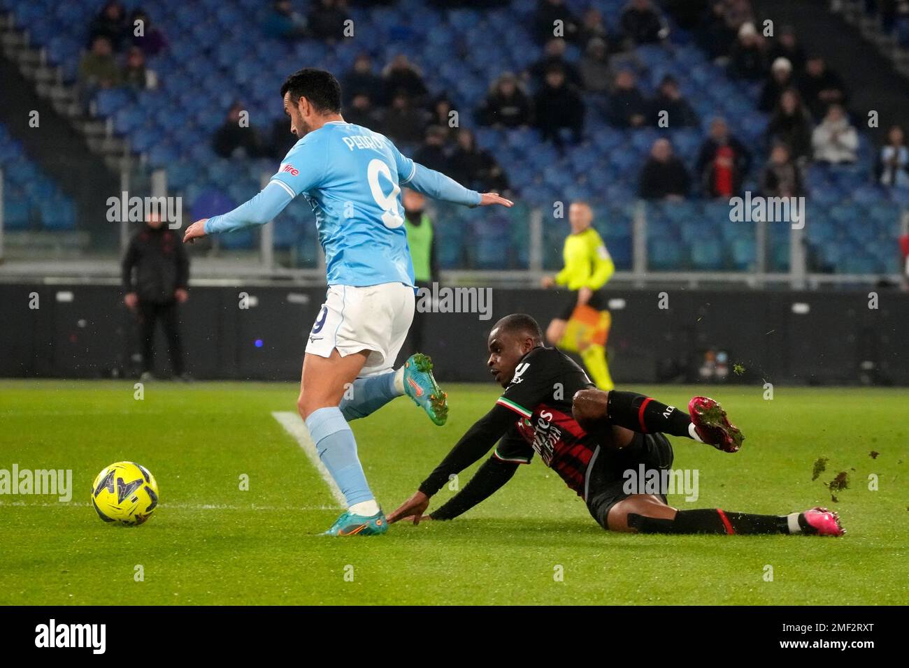 AC Milan's Pierre Kalulu falls as Lazio's Pedro goes for the ball ...