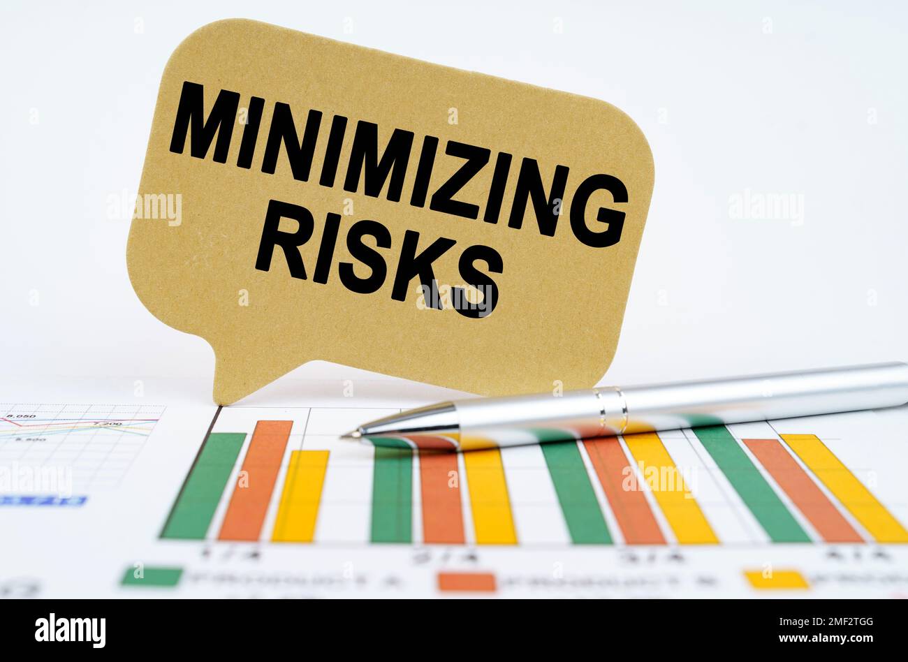 Business concept. On the financial charts lies a pen and a sign with ...