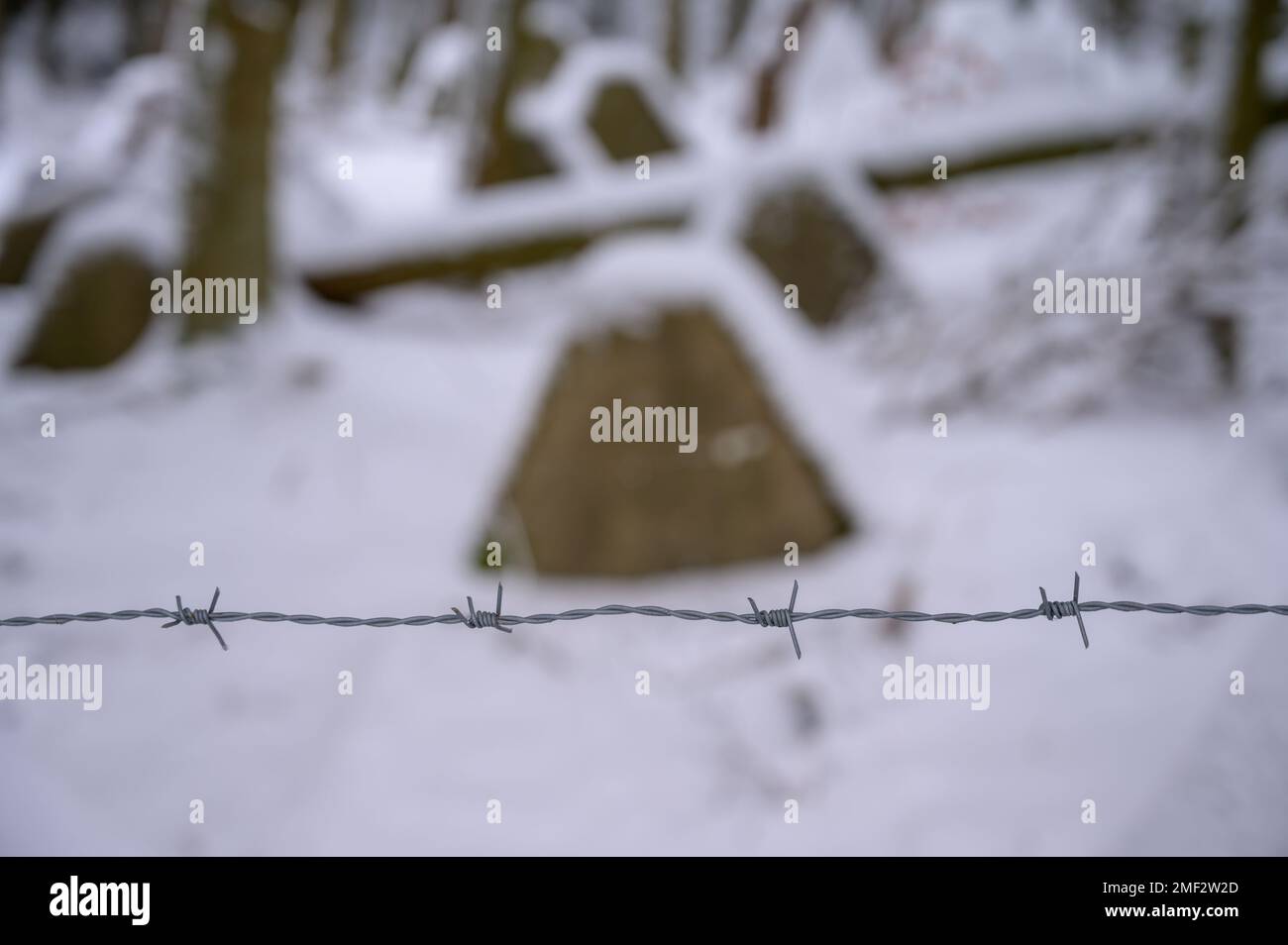 Close-up of barbed wire in front of an anti tank barrier known as ...