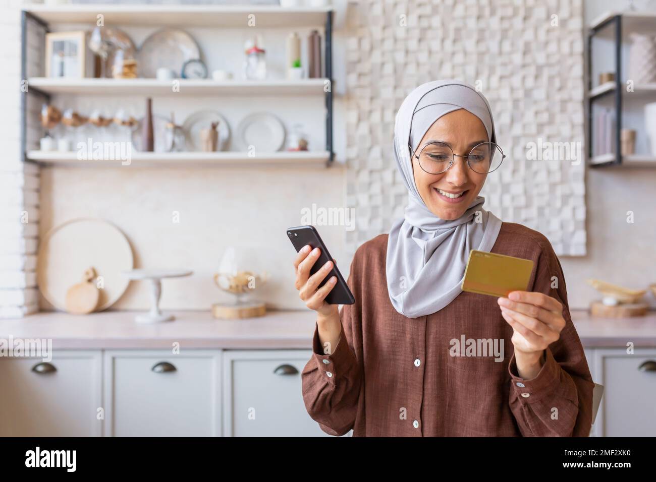 Beautiful muslim girl close up in kitchen, woman in hijab smiling and ...