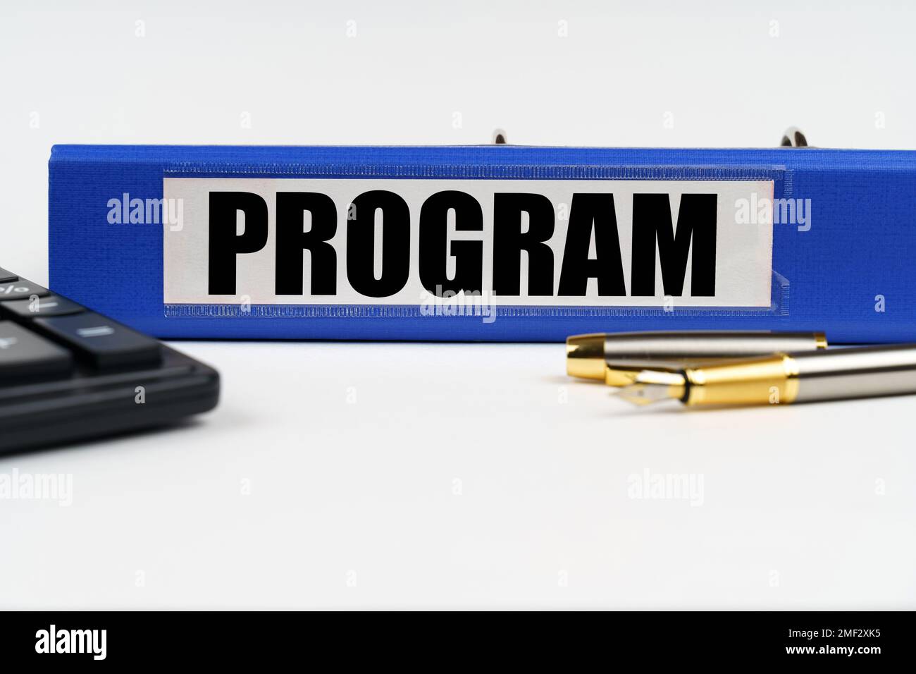 Business concept. On a white surface, a calculator, a pen and a folder ...