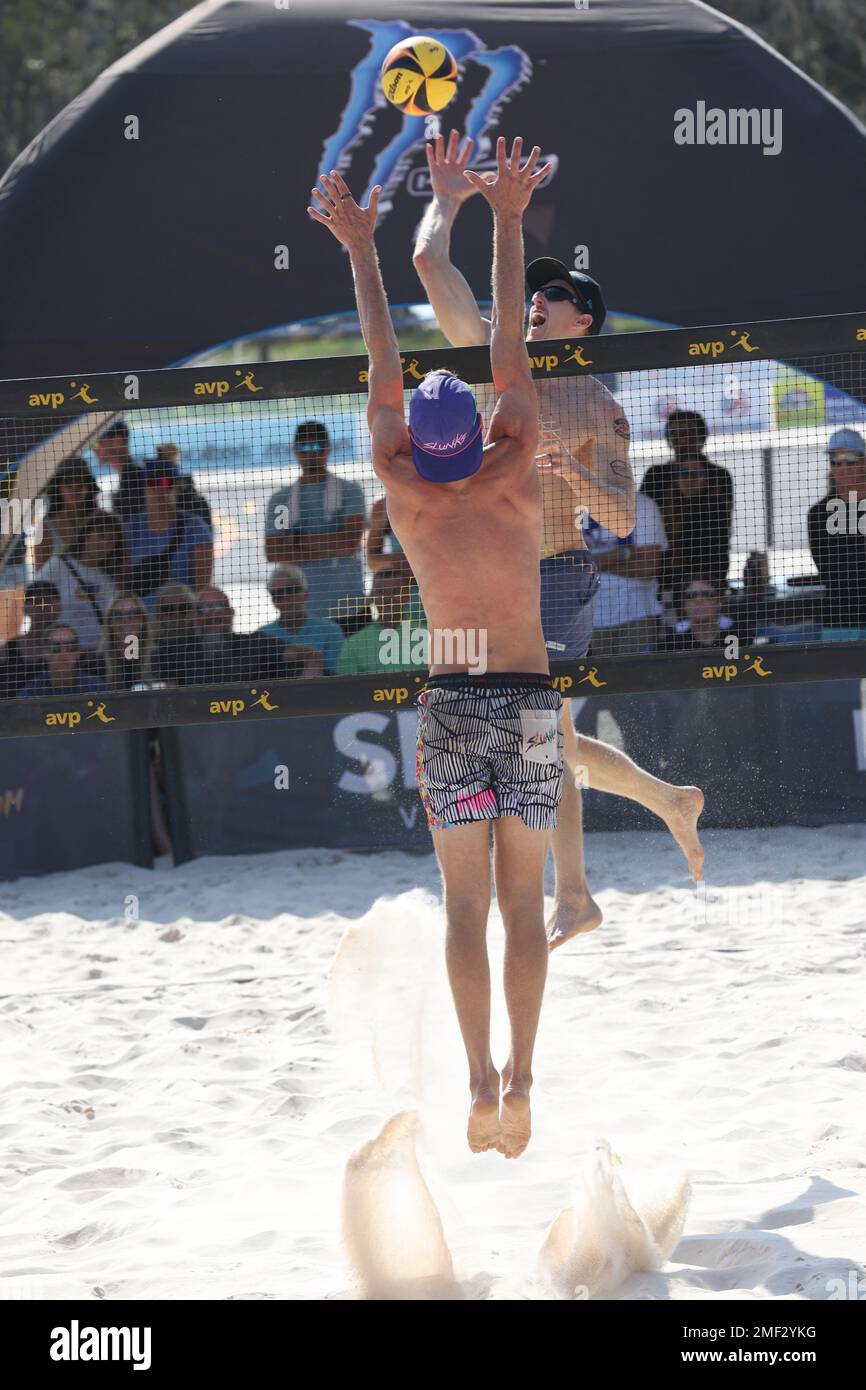Tri Bourne spikes the ball as Timothy Brewster tries to block it at the ...