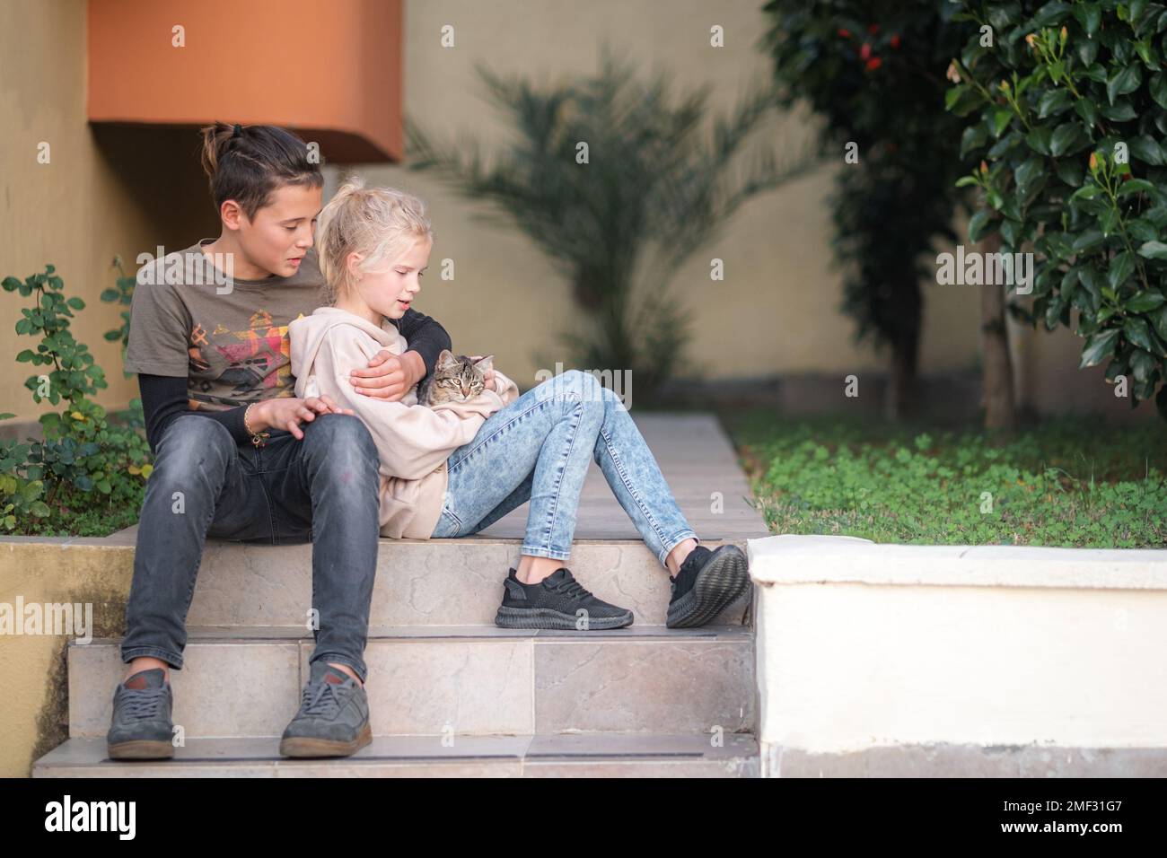 Portrait young teens couple, boy and girl hugging on street, first ...