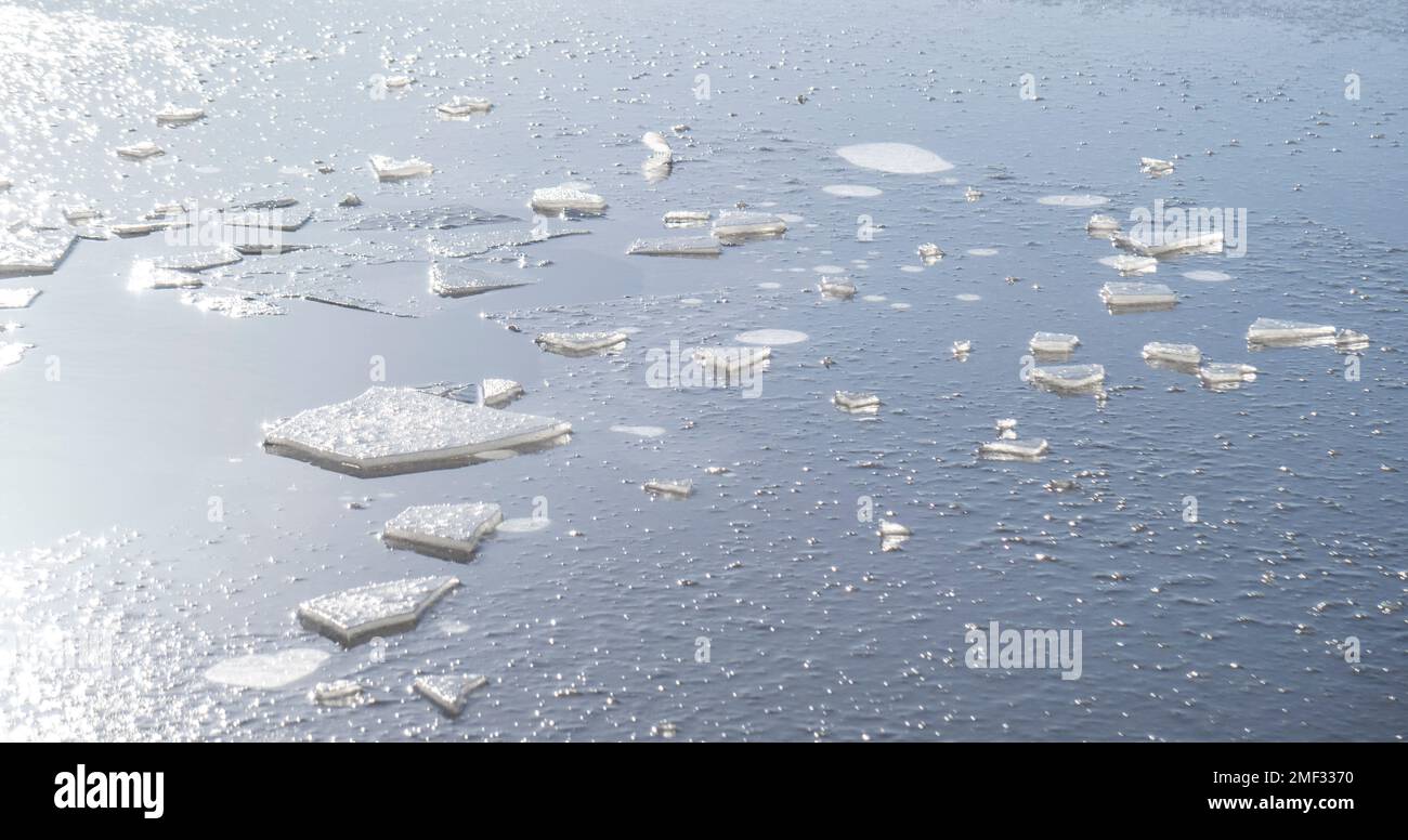 Close up of ice cracks on frozen lake in winter. Layer of freezing ...