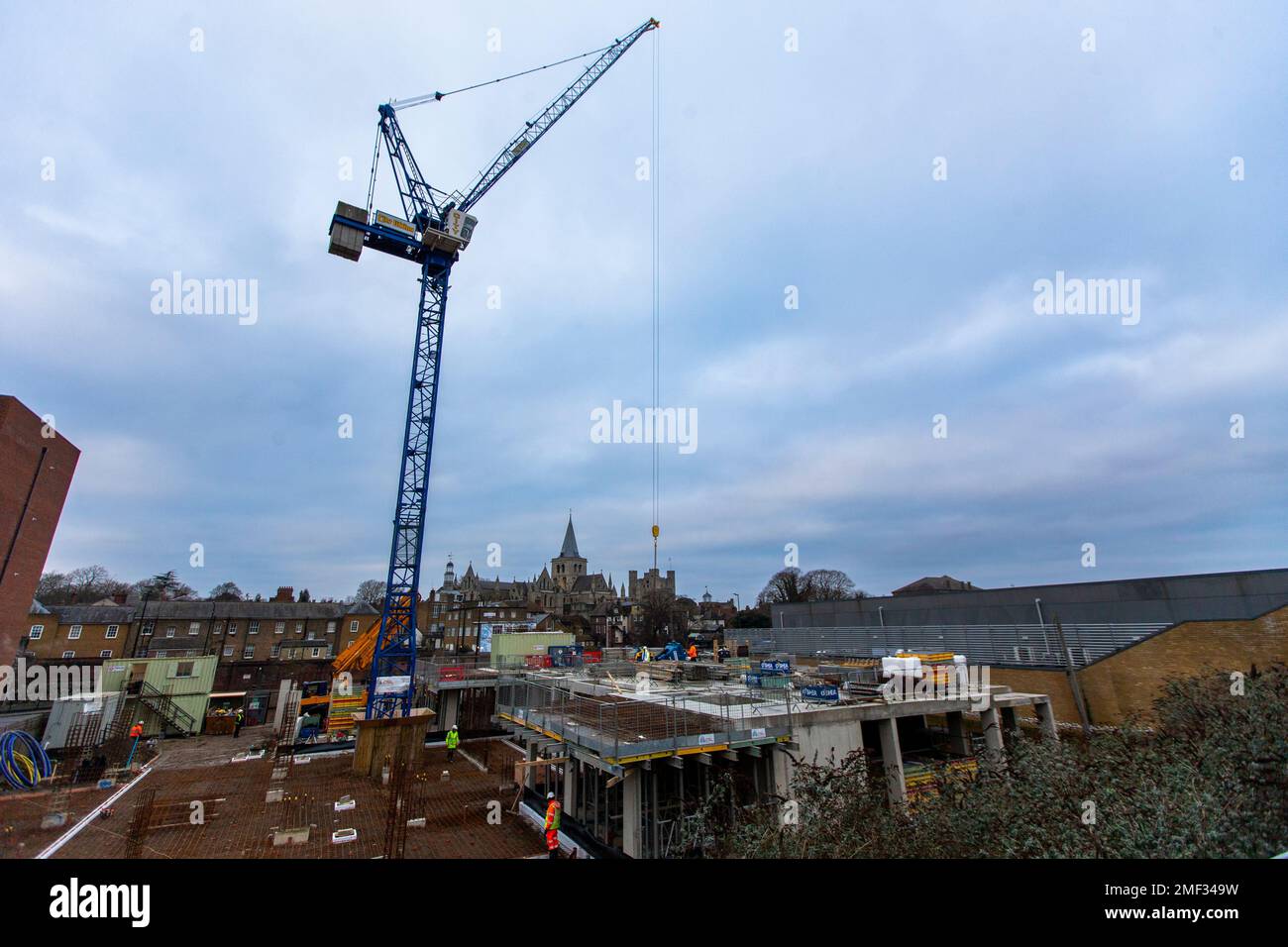 A construction crane works at the side of Rochester railway station ...