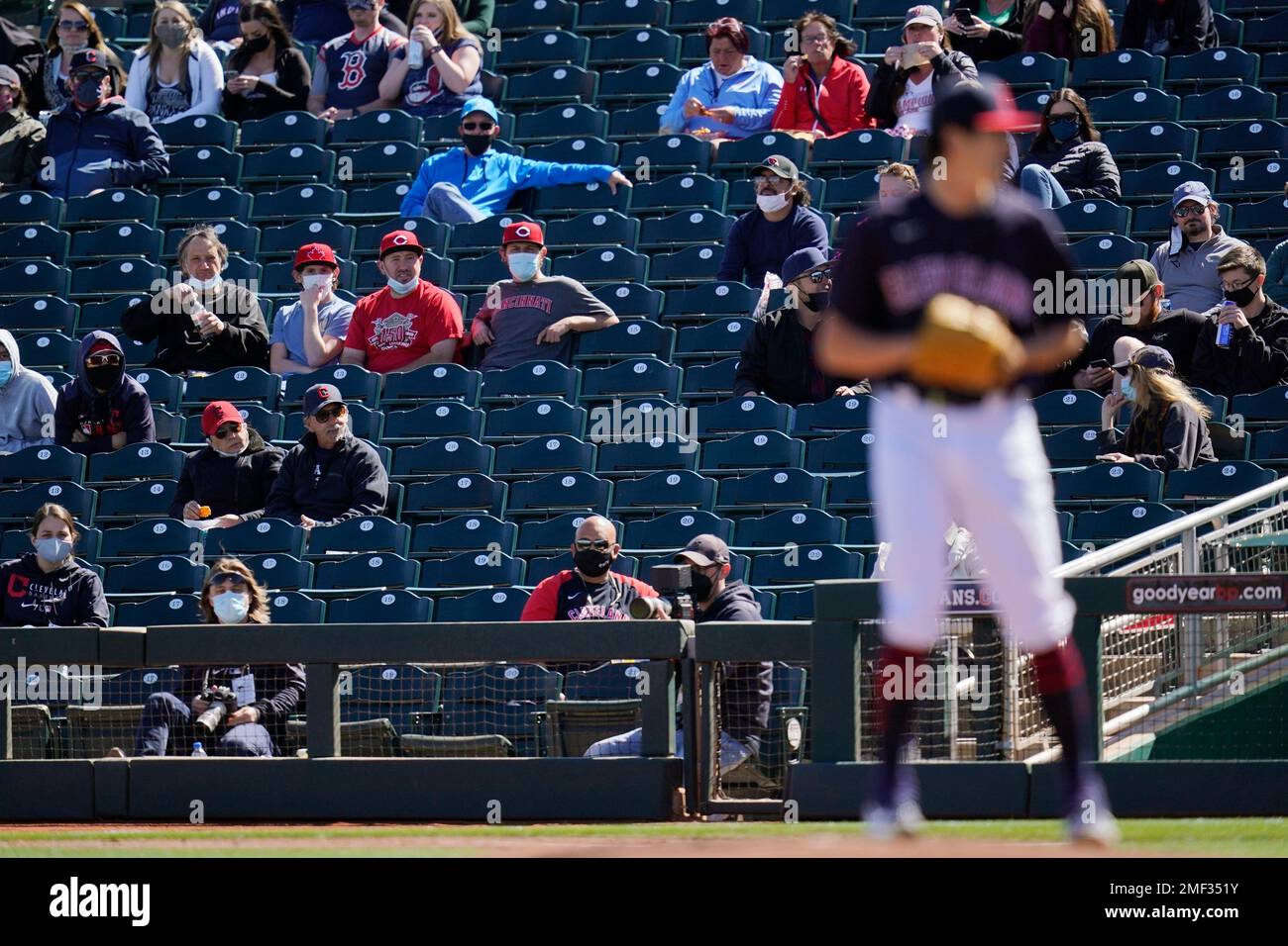 A limited number of fans watch Cleveland Indians pitcher Cal Quantrill ...