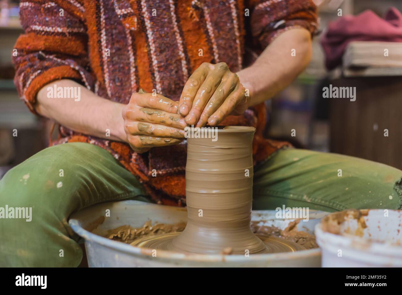 Professional male potter making pot in pottery workshop Stock Photo - Alamy