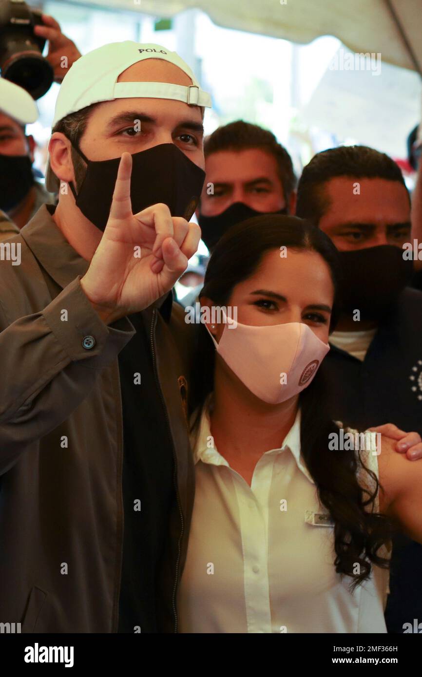 President Nayib Bukele holds up his marked finger after voting, as he ...