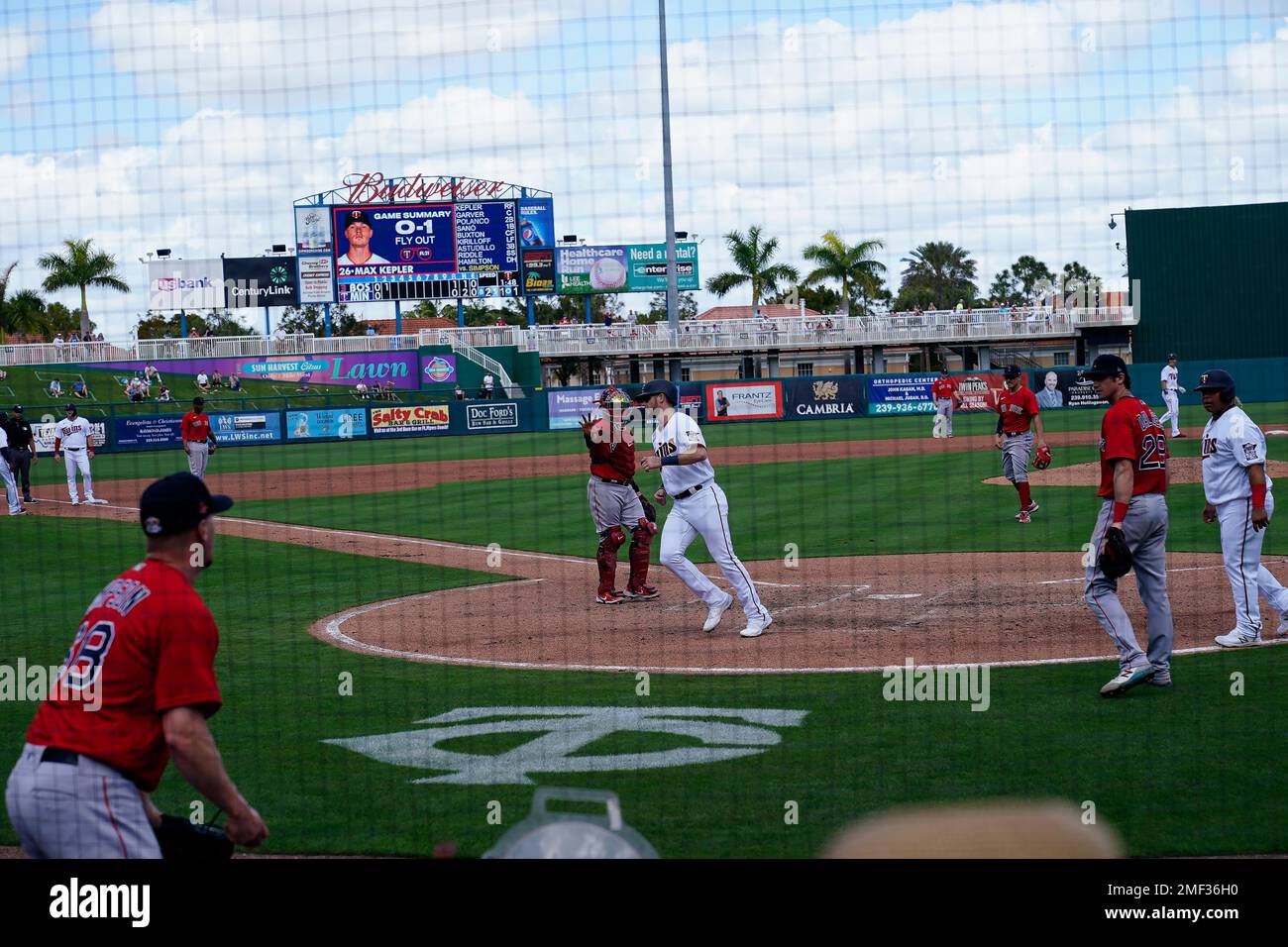 Minnesota Twins' JT Riddle, center, scores during a spring training ...