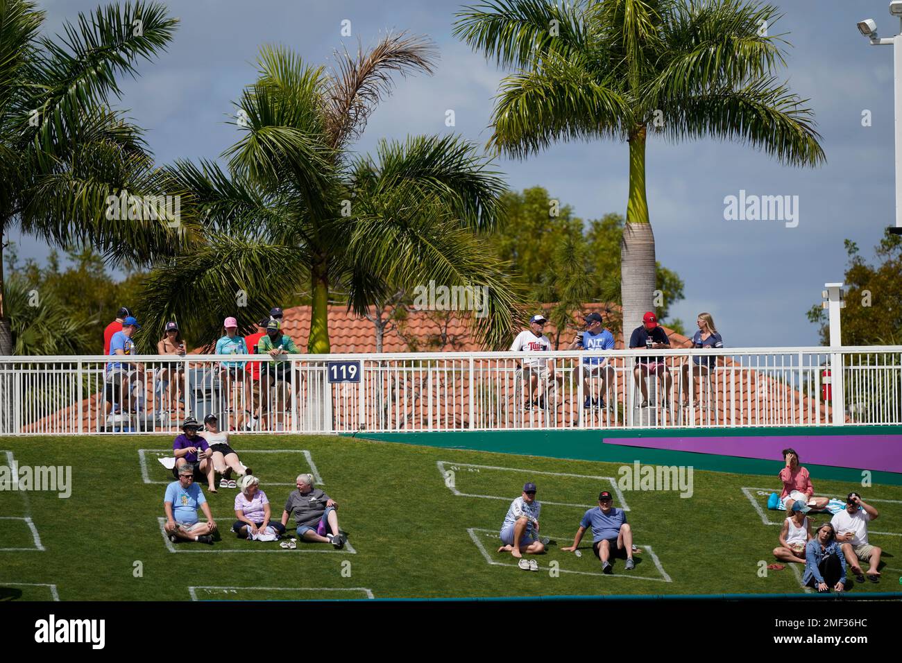 Fans sit in social distance squares during a spring training baseball ...