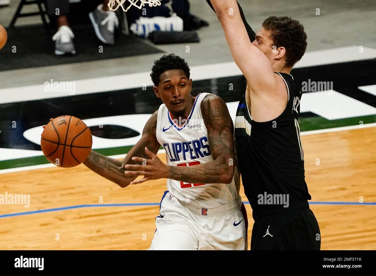 LA Clippers' Lou Williams looks to pass around Milwaukee Bucks' Brook ...