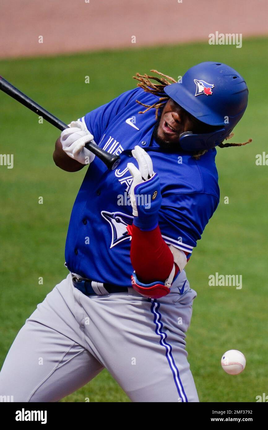 Toronto Blue Jays' Vladimir Guerrero Jr. reacts after being hit by a ...