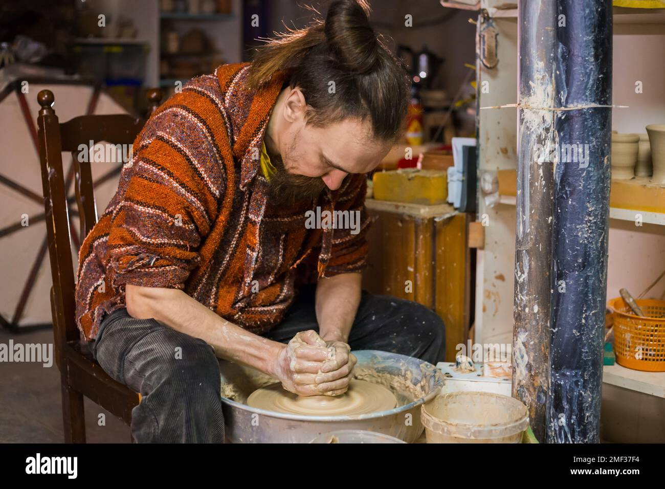 Professional male potter making clay cup in workshop Stock Photo - Alamy