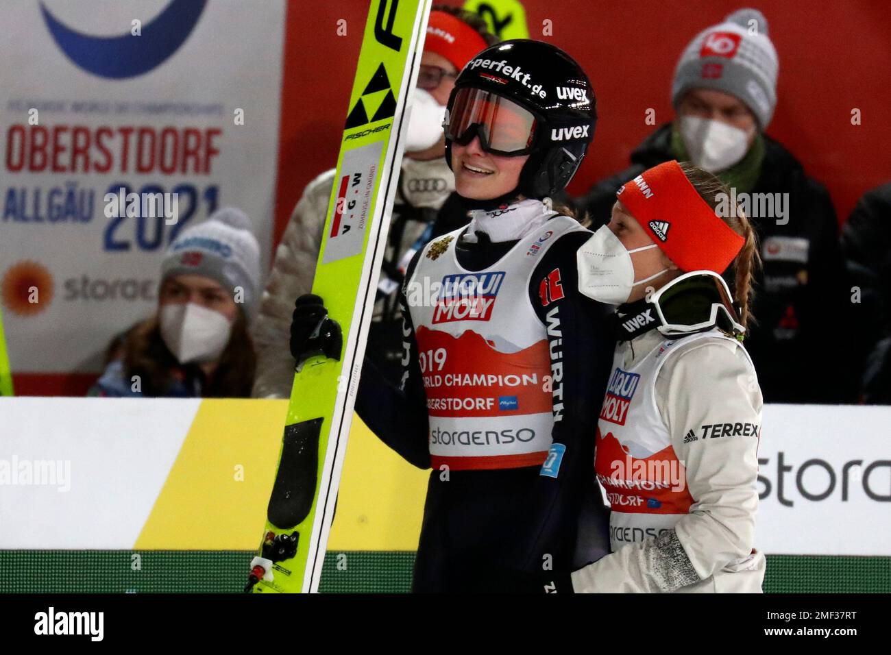 Germany's Anna Rupprecht smiles, with teammate Katharina Althaus, after ...