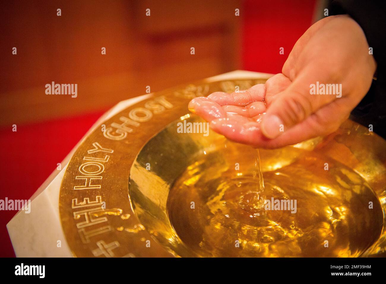 Baptism water in palm of pastor's hand Stock Photo - Alamy