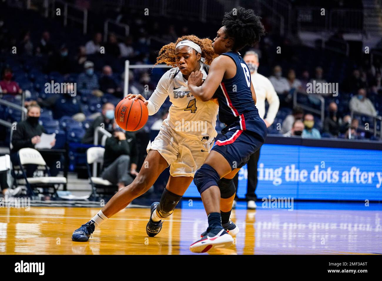 Butler guard Okako Adika (4) drives against Connecticut guard Christyn ...
