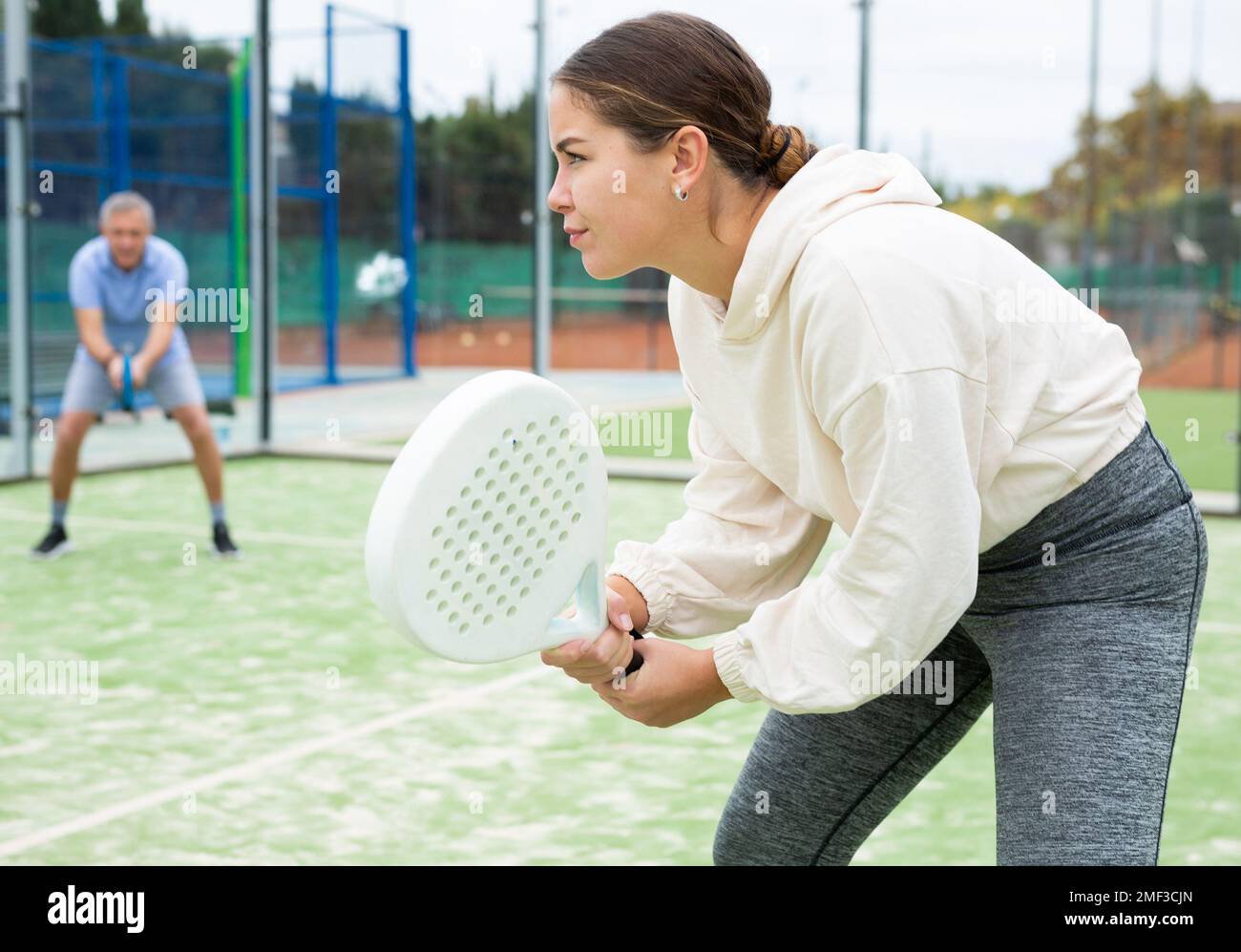 Young sporty woman playing paddle tennis outdoors Stock Photo - Alamy