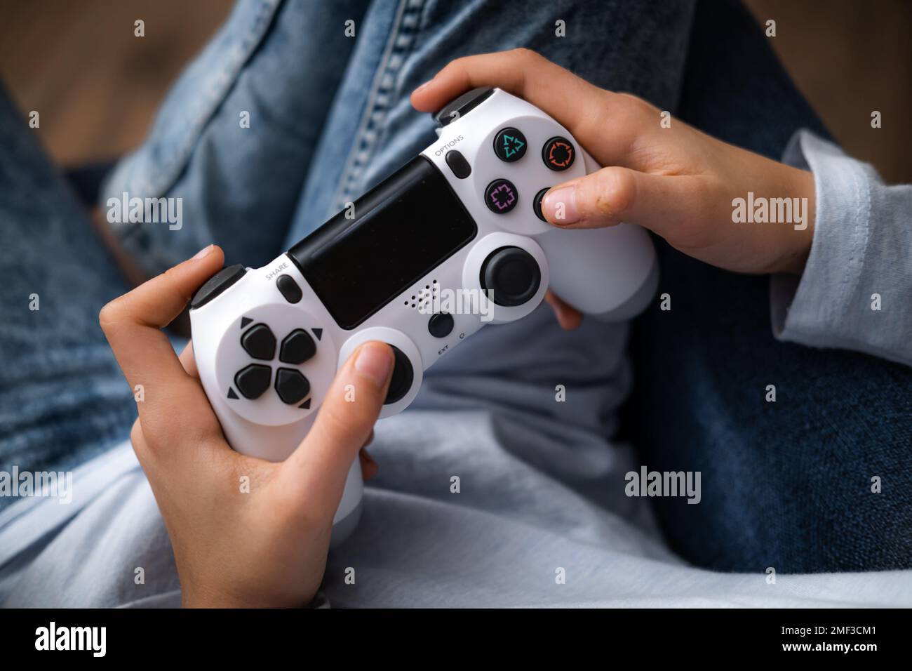 kids hands with joystick, child playing video game console while ...