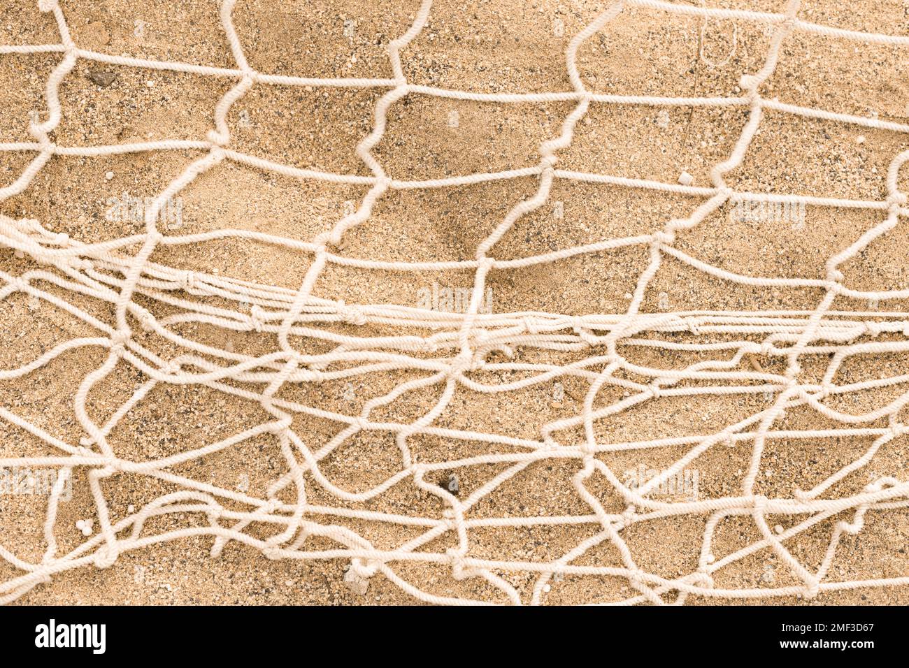 Fishnet on the sand. Fishnet. Woven mesh texture Stock Photo - Alamy