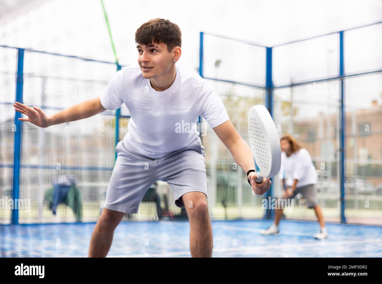 Guy paddle tennis player performing left-handed forehand Stock Photo ...