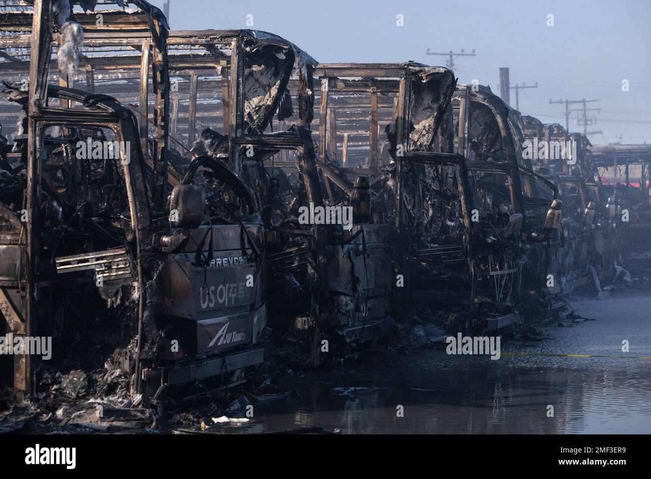The burned buses are seen at a commercial yard in Compton, Calif., on ...