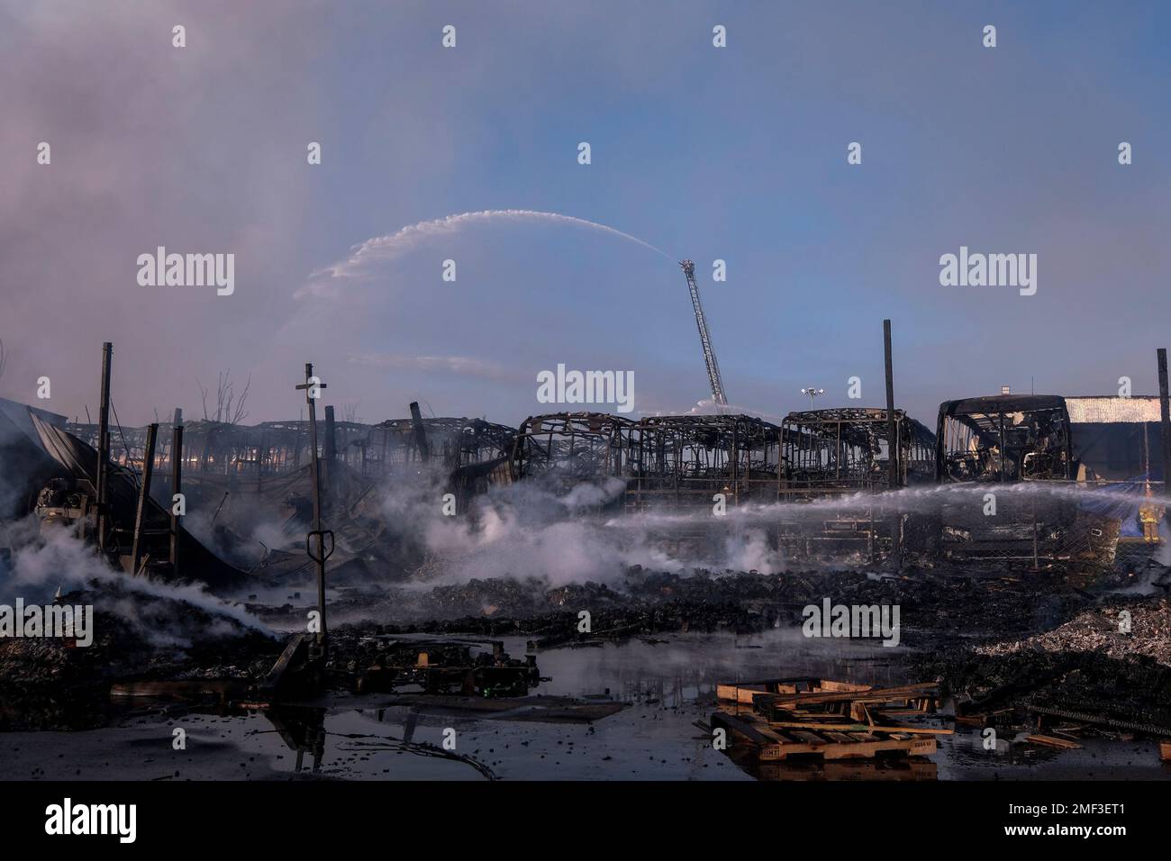 Firefighters battle a fire at a commercial yard in Compton, Calif., on ...