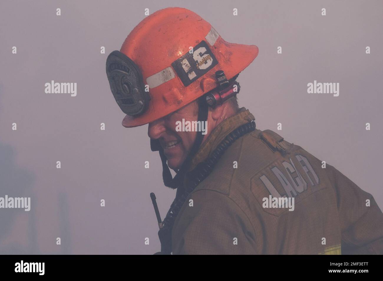 A firefighter battles a fire at a commercial yard in Compton, Calif ...