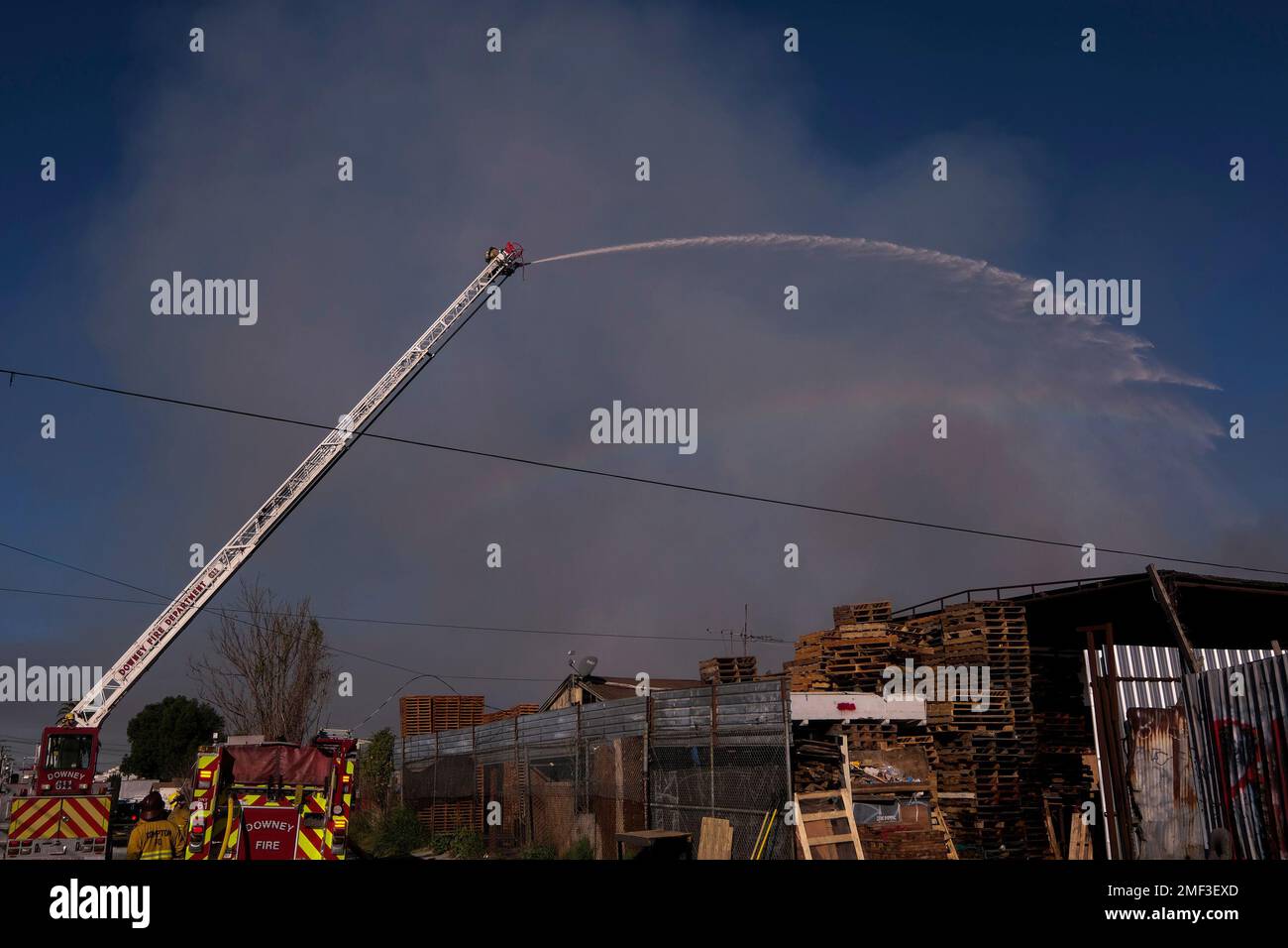 Firefighters battle a fire at a commercial yard in Compton, Calif., on ...