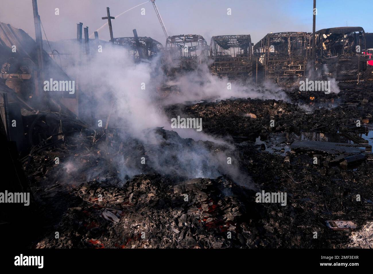 Firefighters battle a fire at a commercial yard in Compton, Calif., on ...