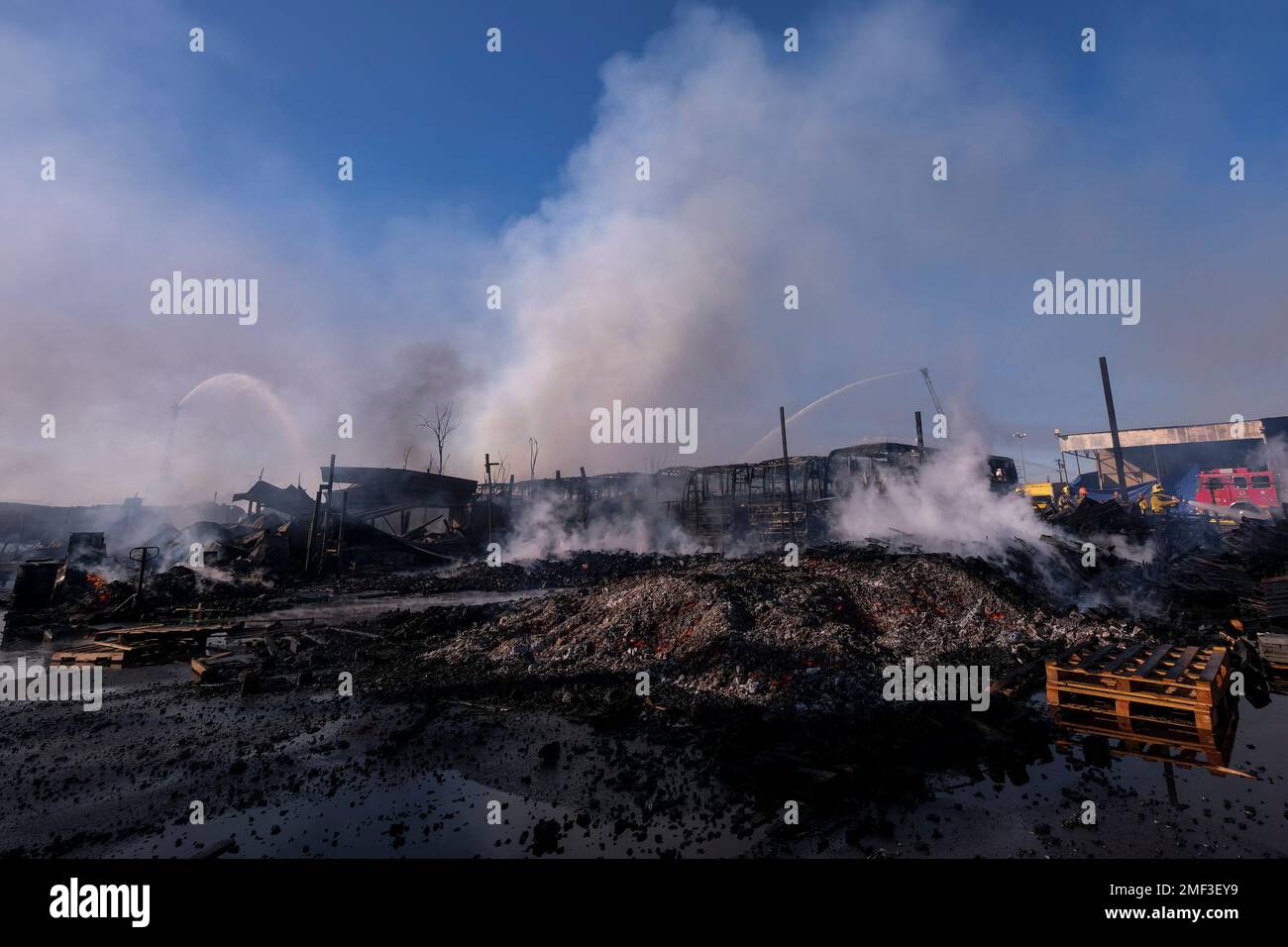 Firefighters battle a fire at a commercial yard in Compton, Calif., on ...