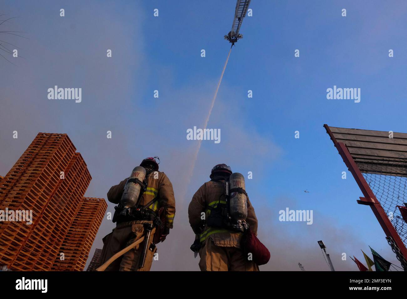 Firefighters battle a fire at a commercial yard in Compton, Calif., on ...