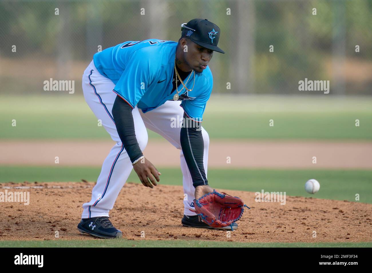 Miami Marlins pitcher Sixto Sanchez handles a grounder during a drill ...