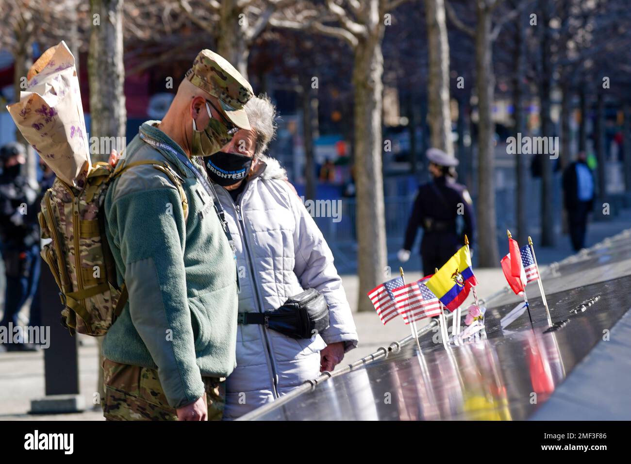 Sgt. Edwin Morales, left, and Freyda Markow pay their respects to ...