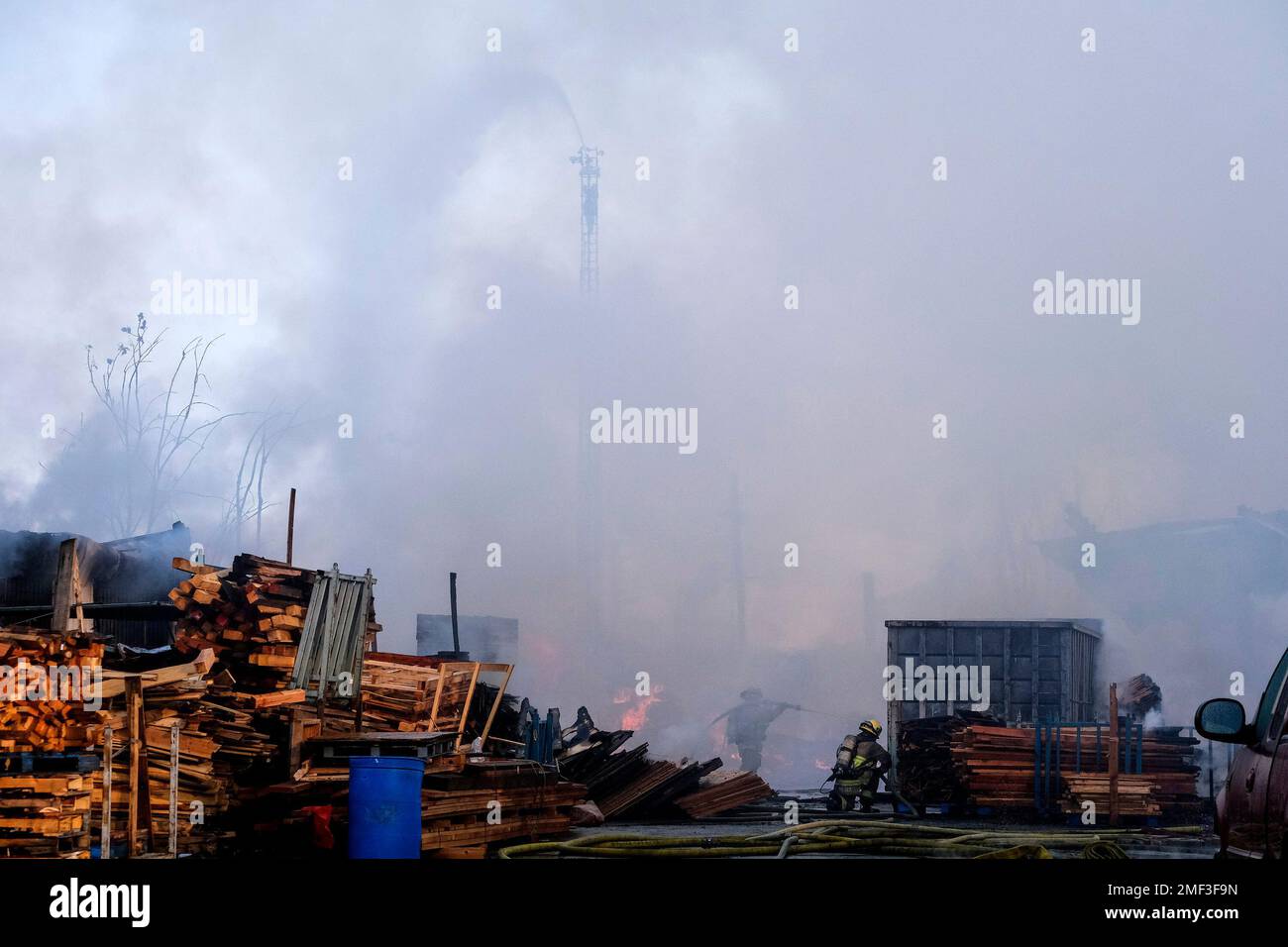 Firefighters battle a fire at a commercial yard in Compton, Calif., on ...