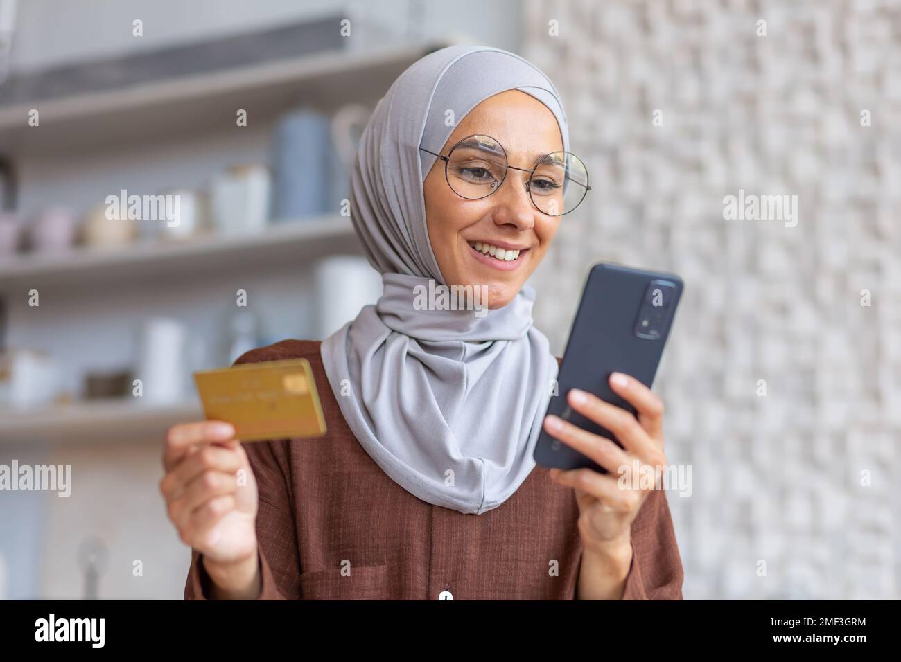 Beautiful muslim girl close up in kitchen, woman in hijab smiling and ...