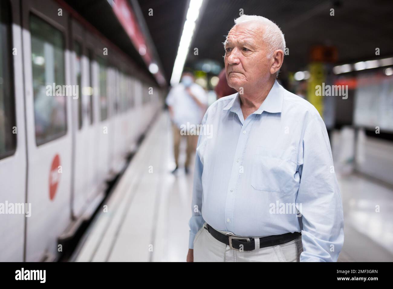 Senior man standing in front of subway train Stock Photo - Alamy