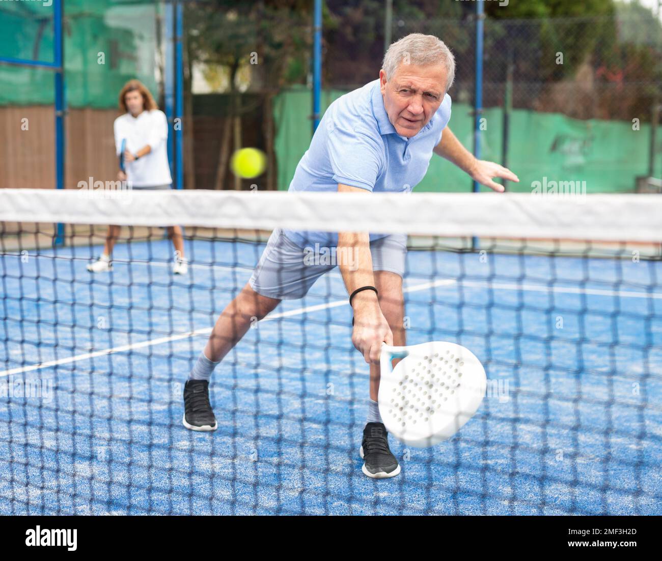 Emotional mature man playing paddle tennis outdoors Stock Photo - Alamy